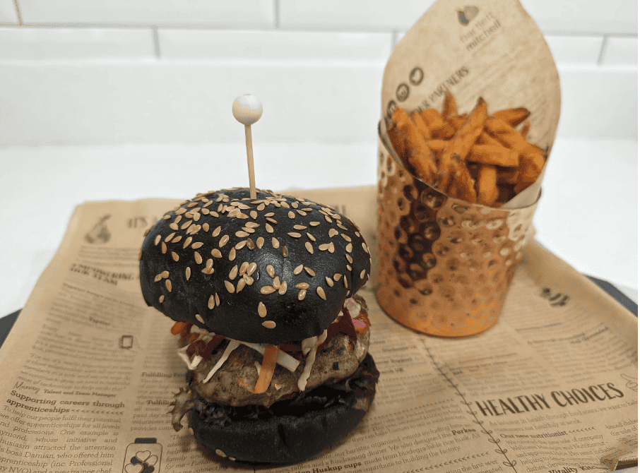 Caribbean plantain & bean burger in a charcoal and linseed bun with ...